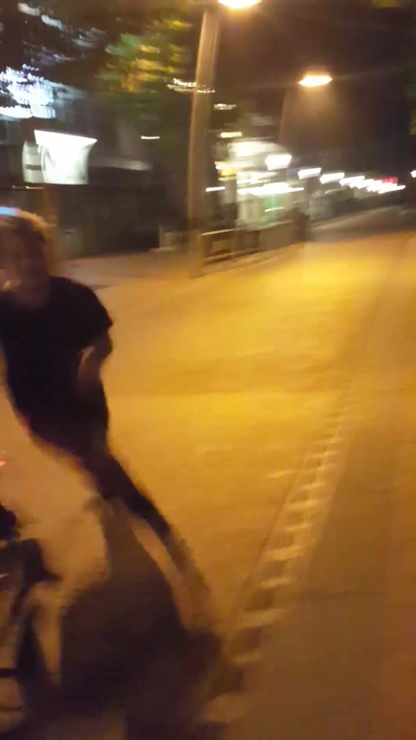 Girl in blue shirt is chasing man and falls into brick wall face first