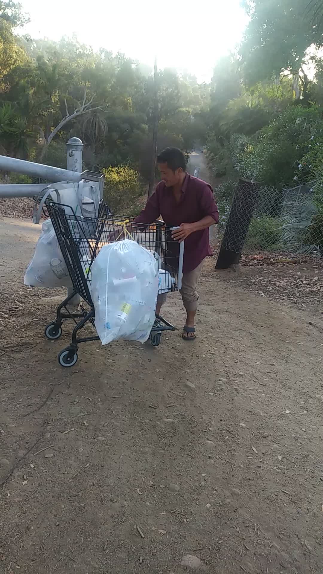 Homeless Man Rides Cart to Collect Cans
