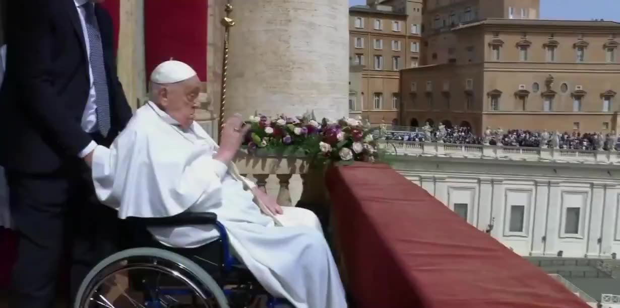 Pope Francis greets the faithful from the Vatican balcony at Easter