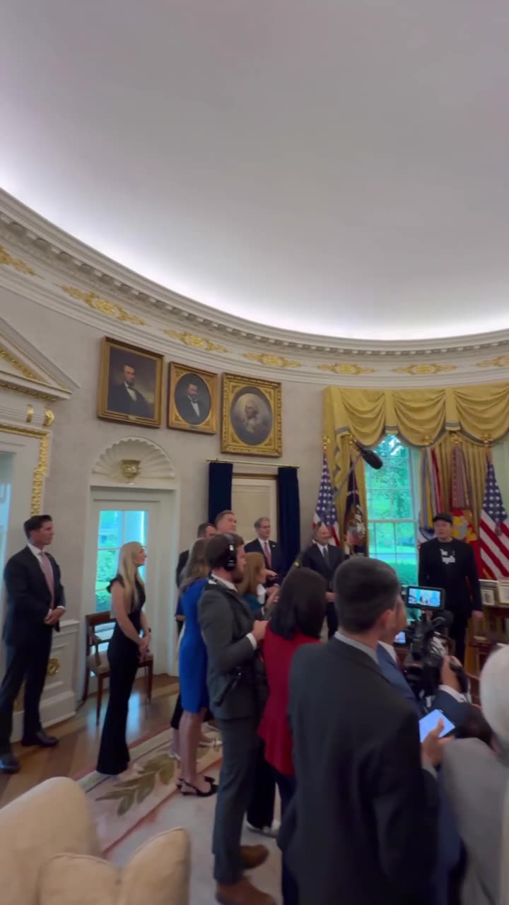 President Trump was seated behind the Resolute Desk. Elon Musk was ...