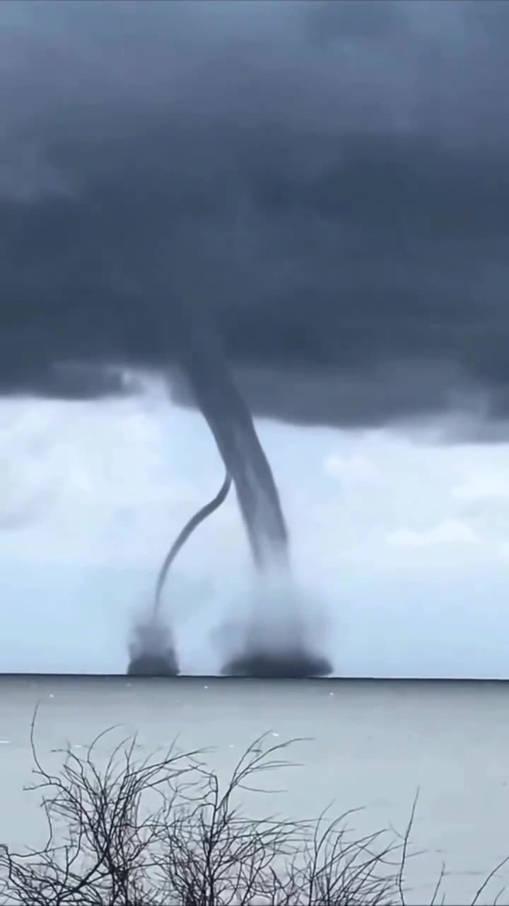 Terrifying scene of a double funnel clouds