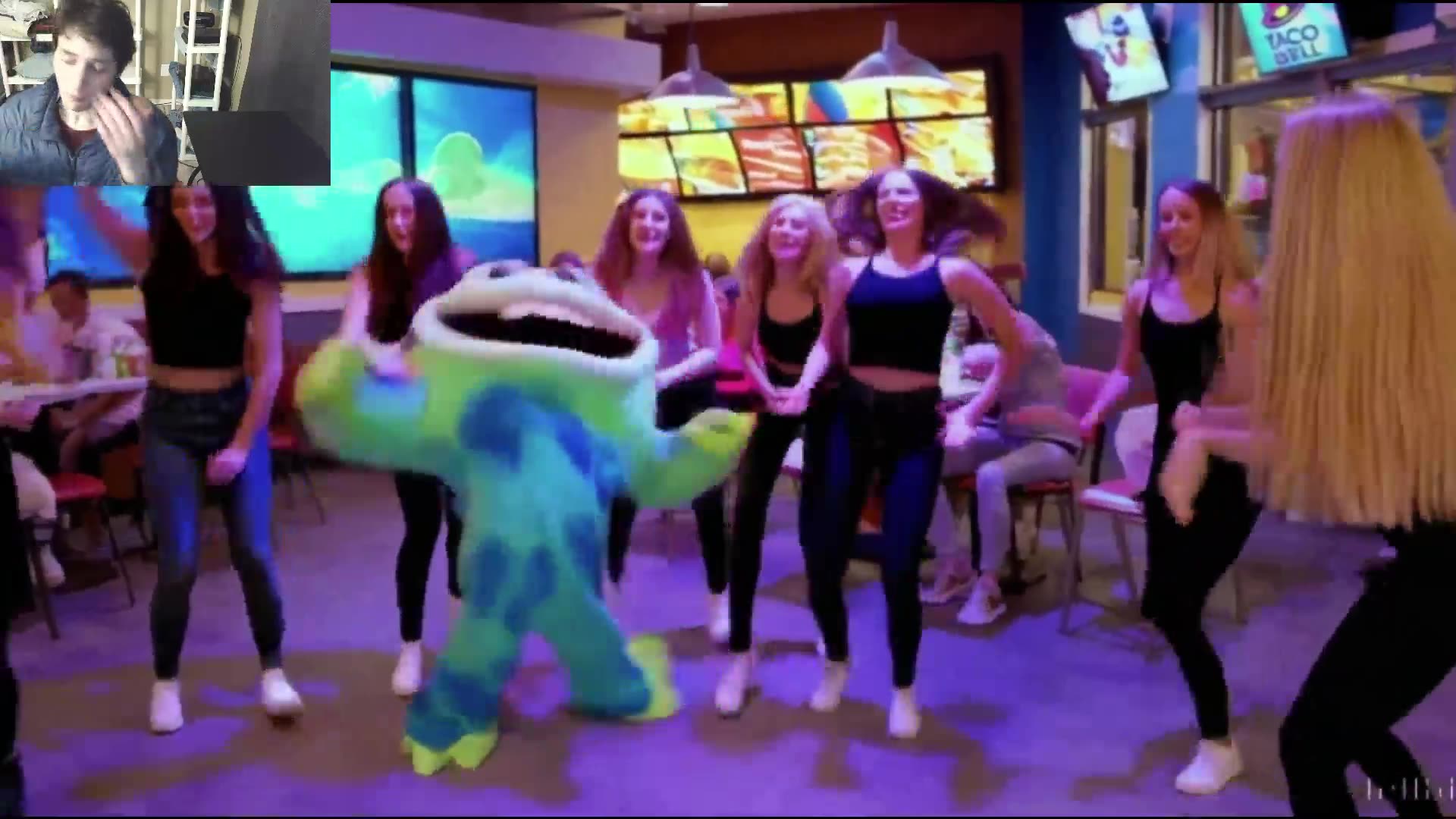 Blue Aquatic Creature Dancing With Women At A Taco Bell Restaurant Fake ...