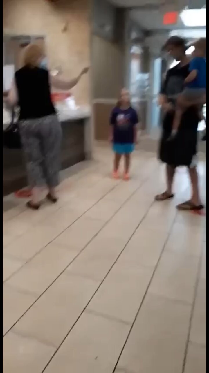 Brainwashed woman makes children cry because they wear no masks