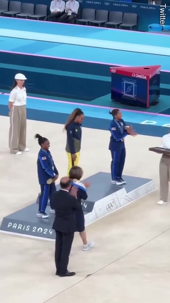 Simone Biles and Jordan Chiles bow down to Rebeca Andrade on podium