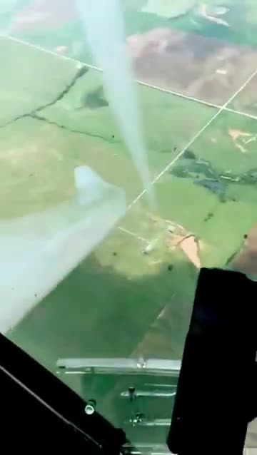 A pilot flying next to a landspout tornado during its formation