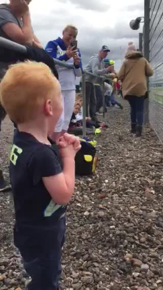 Boy Shakes With Excitement At Seeing Motorbikes Race For The First Time