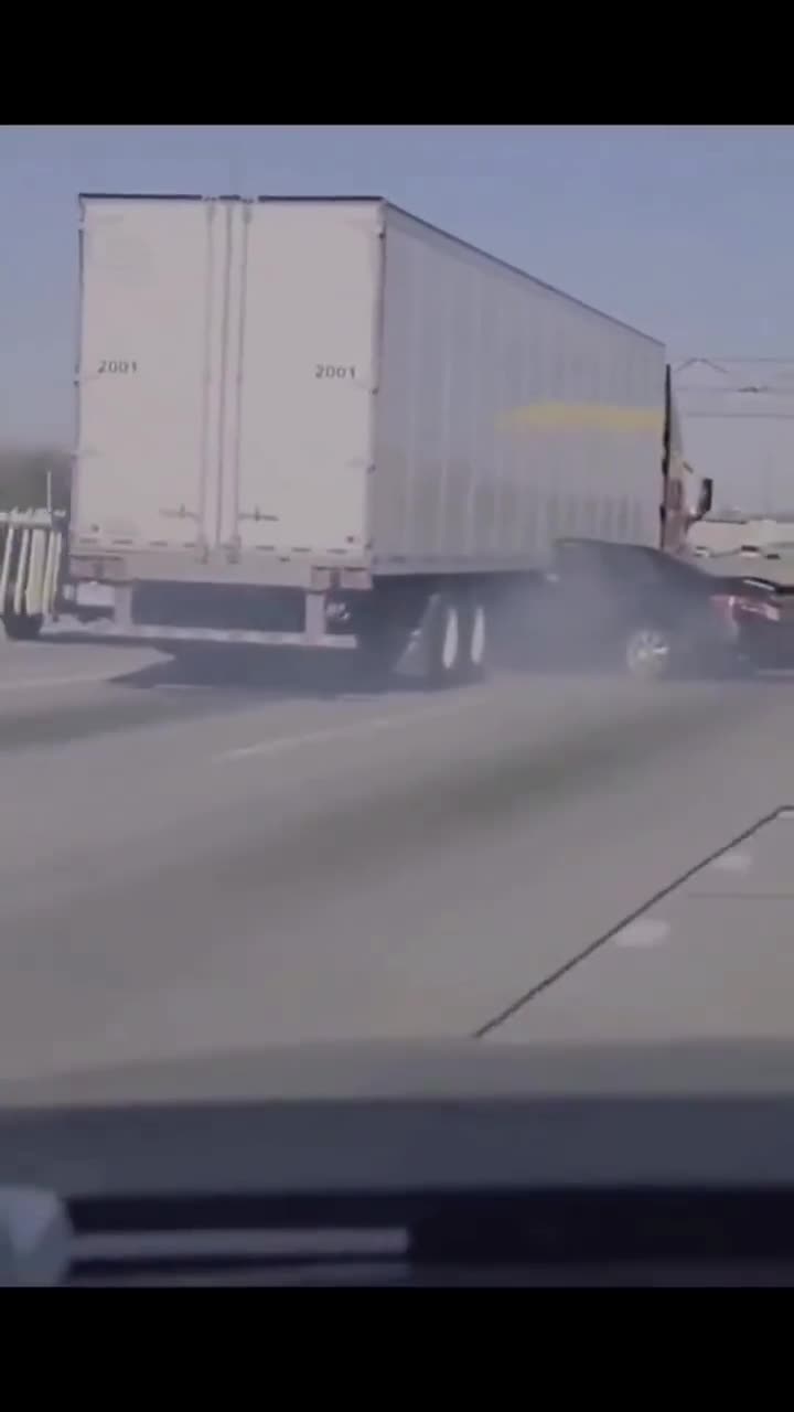 Driver desperately waves for help as a semi-truck dragged her car ...