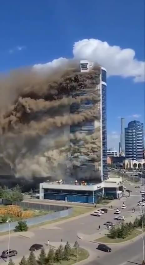 Massive fire large plumes of smoke rise from apartment building on fire ...