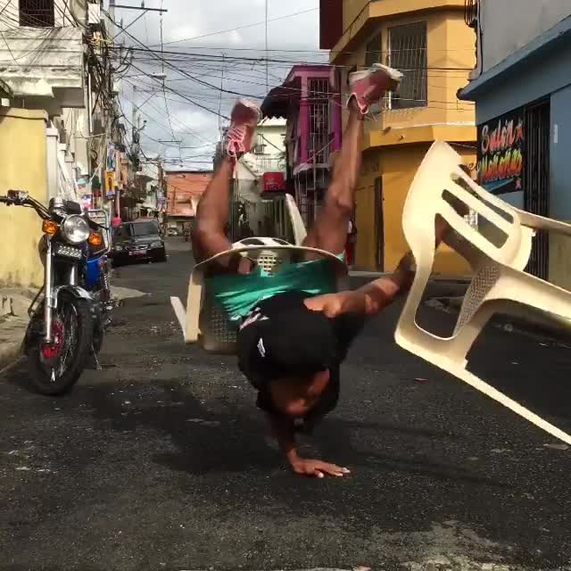 Check out this dude dancing on his hands with plastic chairs