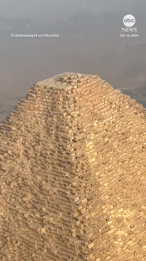 Man Paraglides Over Pyramids and Spots Dog at the Top!