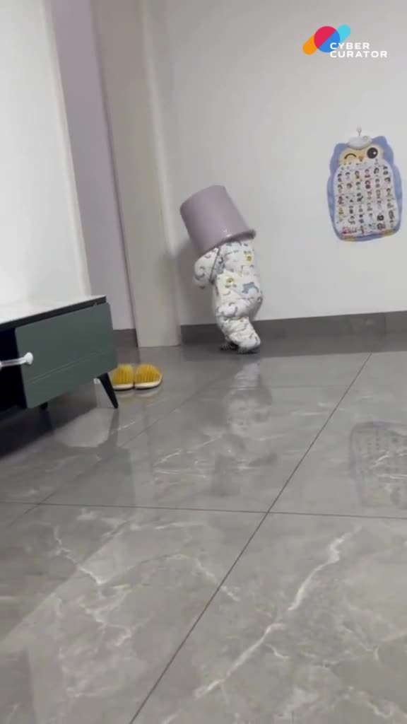 Kid puts empty bucket on head, wanders around bumping into walls! 😂🪣 # ...