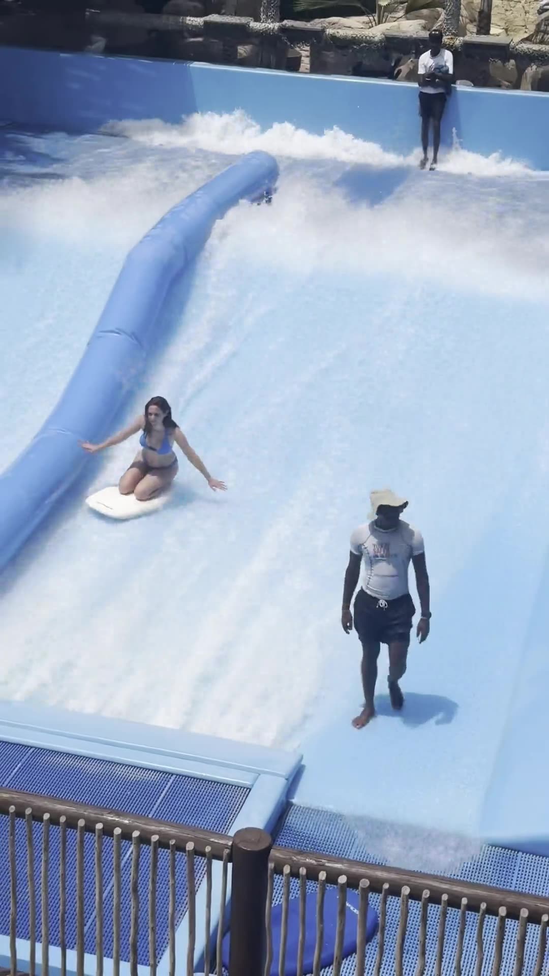 Surf Pool Attendant Is Prepared For Woman's Wipeout