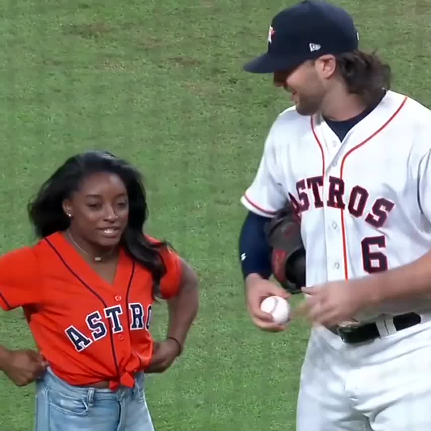Simone Biles flips during incredible first pitch