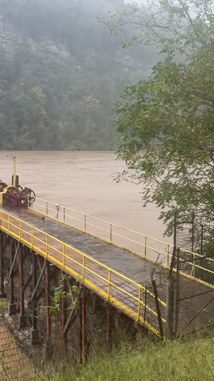 Pontoon Boat Goes Over Flooded Dam in Virginia