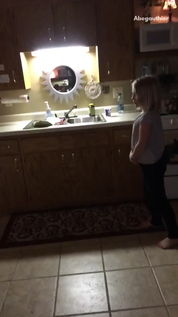 Two little girls fighting in living room kitchen
